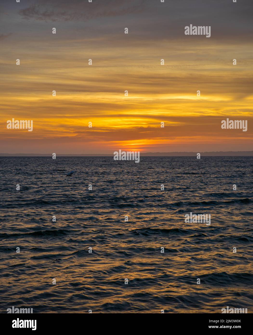 A scenic sunset over an ocean Stock Photo - Alamy