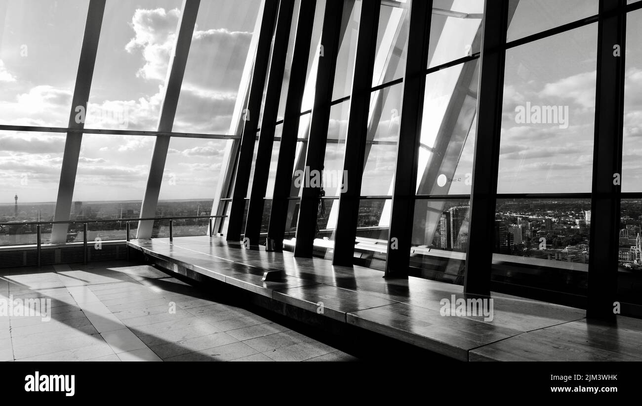 A grayscale shot of interior of modern floor and with glass big windows ... A grayscale shot of interior of modern floor and with glass big windows ...