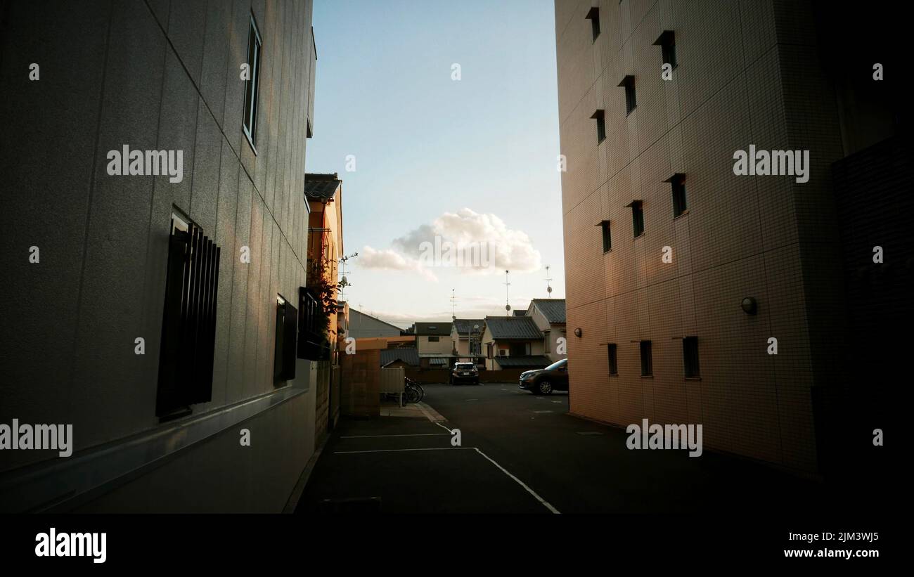 An alley between two buildings in late afternoon Stock Photo - Alamy