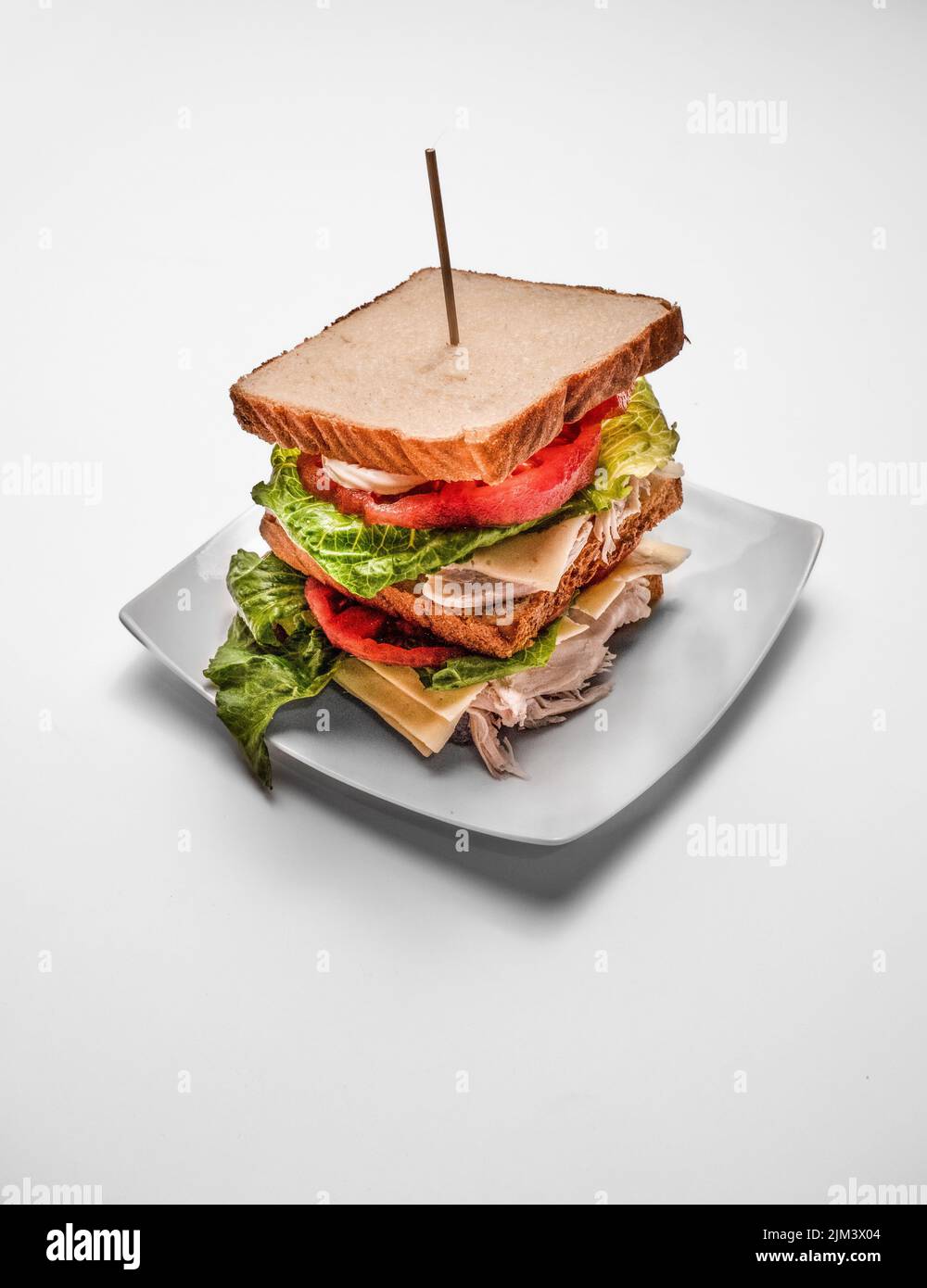 A vertical shot of a club sandwich on a white background Stock Photo ...