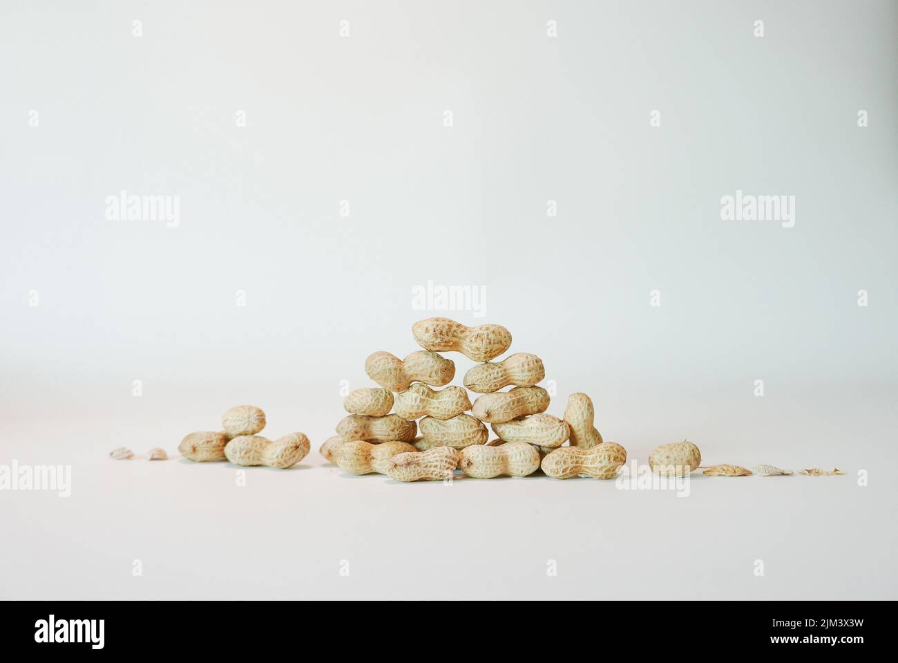 A Stack Of Peanuts On Top Of Each Other On A White Background Stock