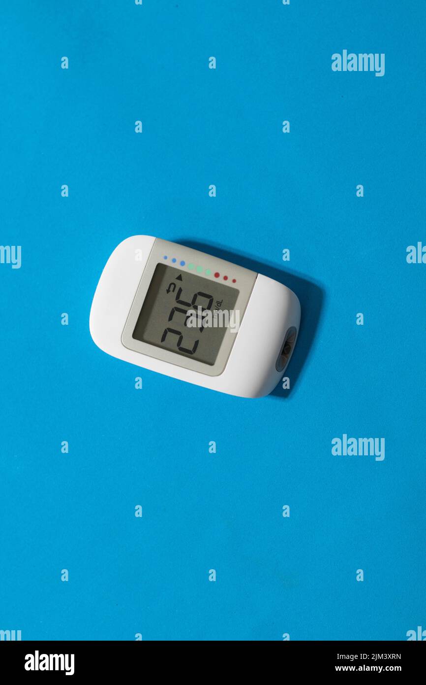 Vertical shot of a glucometer showing glucose in the blood Devices for ...
