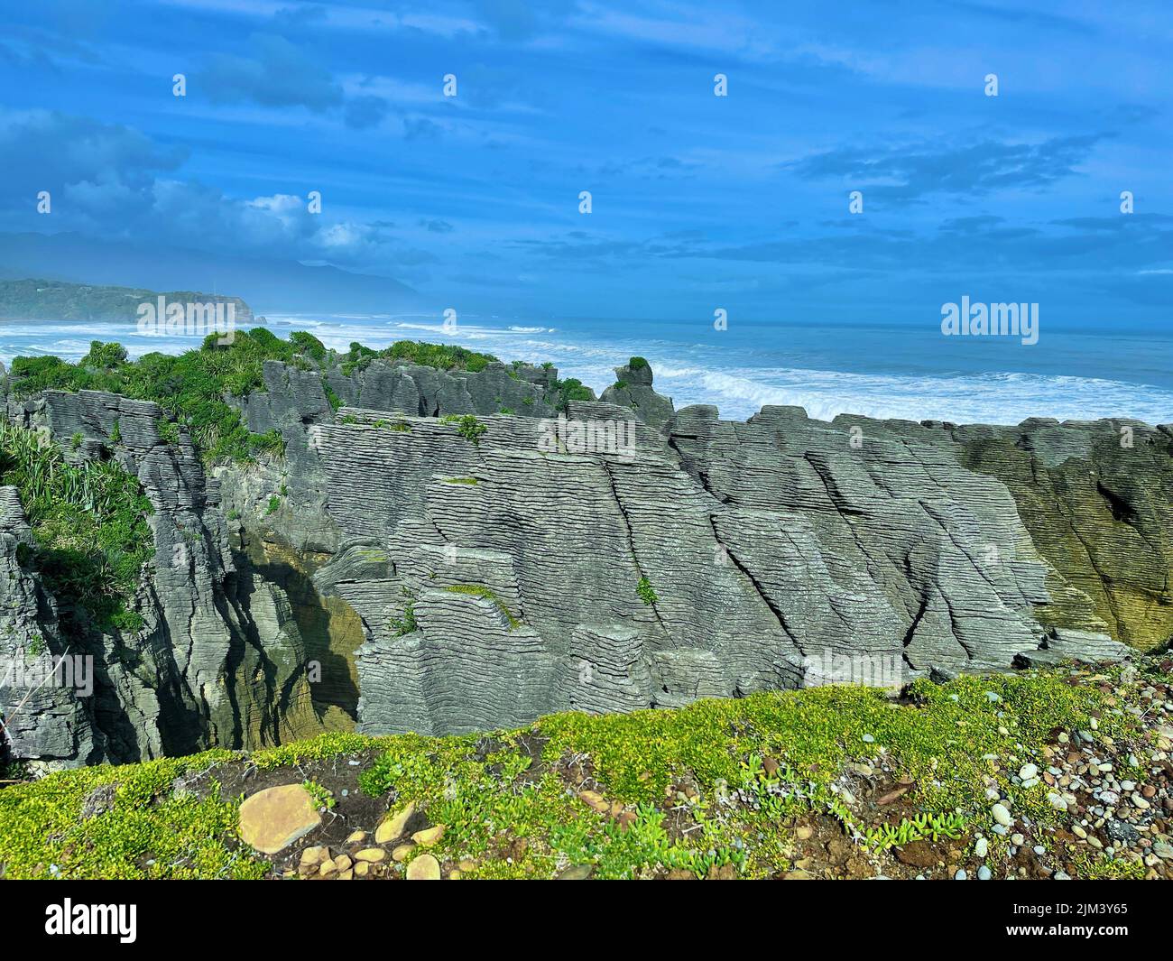 A bretahtaking view of a group of rock formations surrounded by lush ...