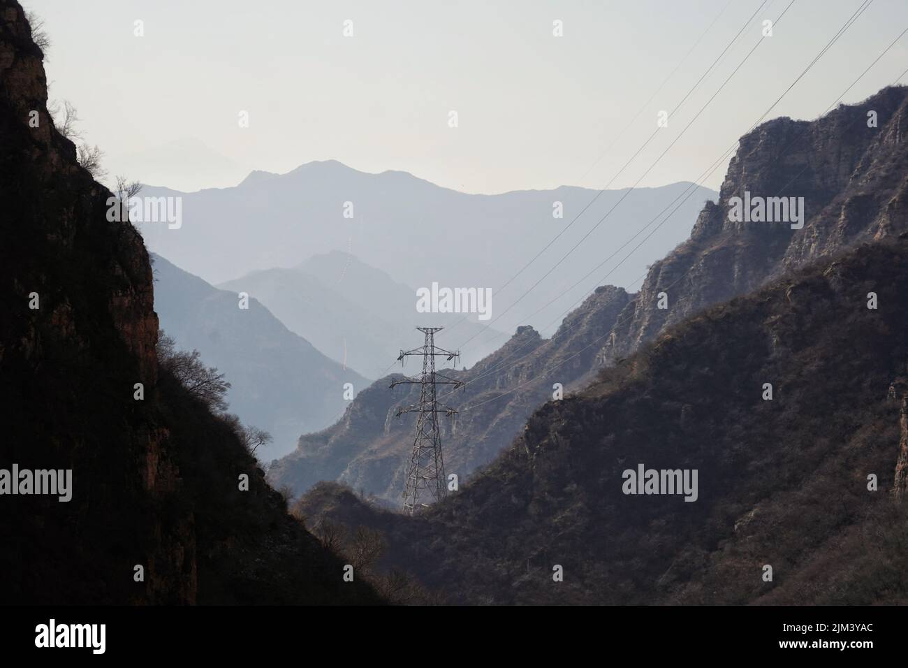 A breathtaking view of a transmission power line in the middle of steep ...