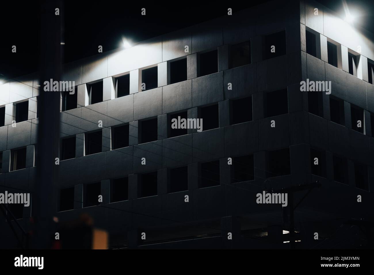 The exterior of a building with lights at night Stock Photo - Alamy