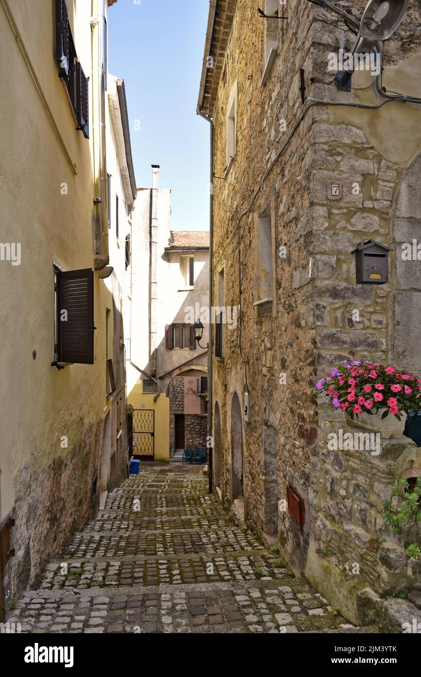 A narrow street among the old houses of Lenola, a medieval village in ...