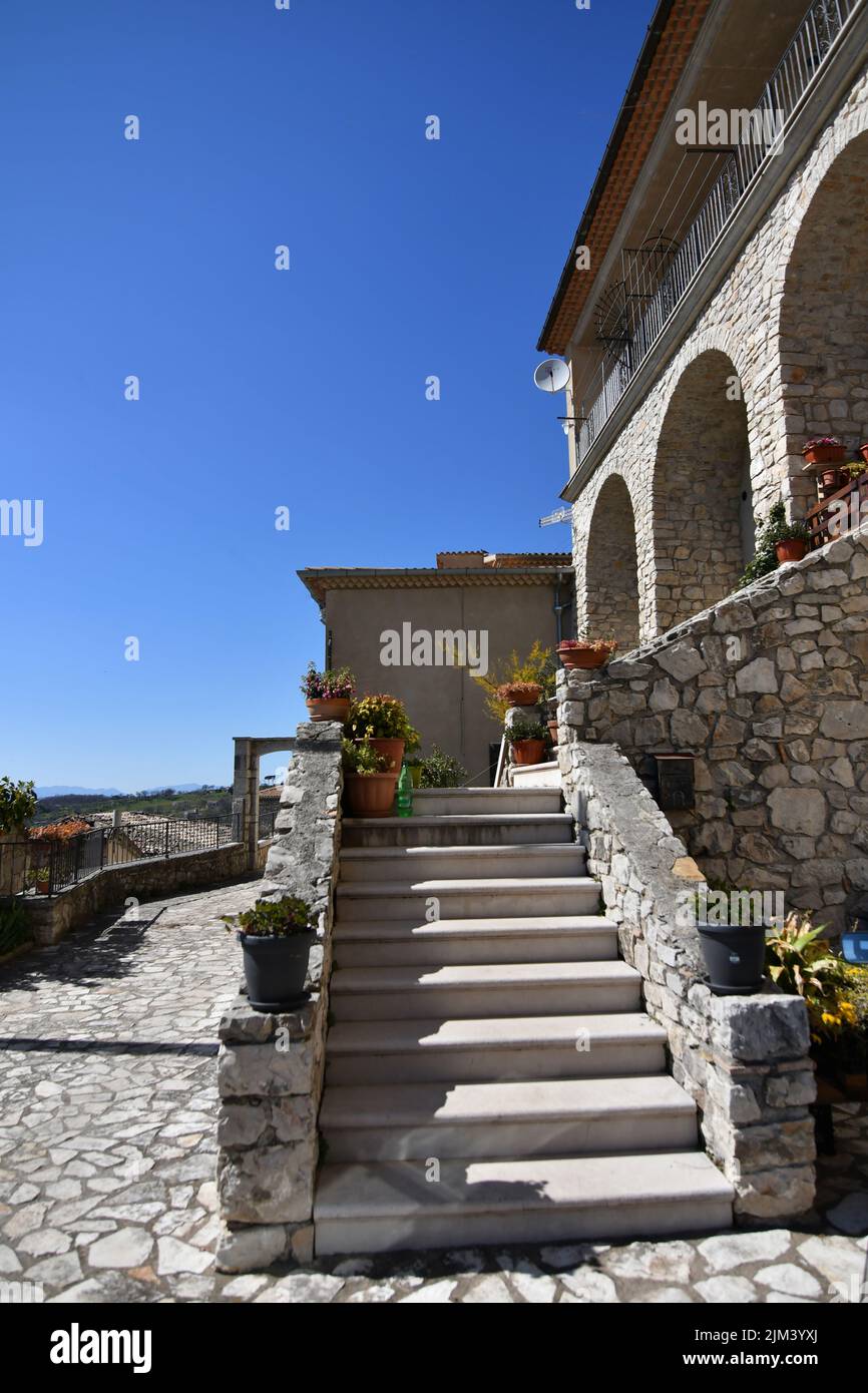 A Narrow brick street with houses under a blue sky in a small village ...