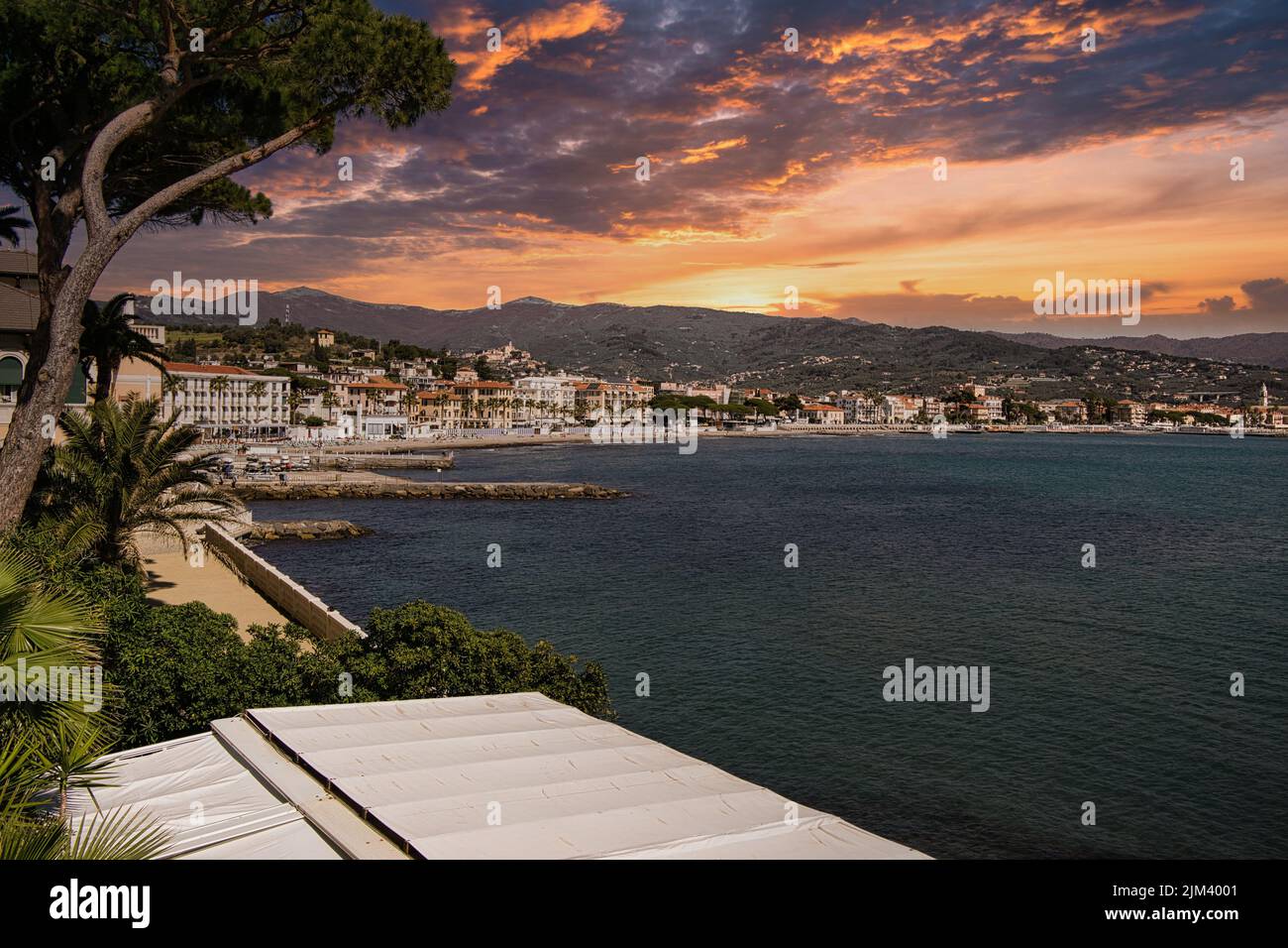 A vibrant sunset scene over a seaside resort Stock Photo - Alamy