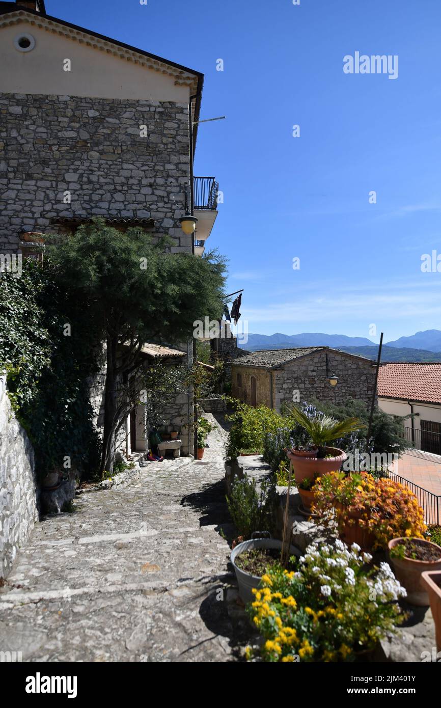 A Narrow brick street with houses under a blue sky in a small village ...