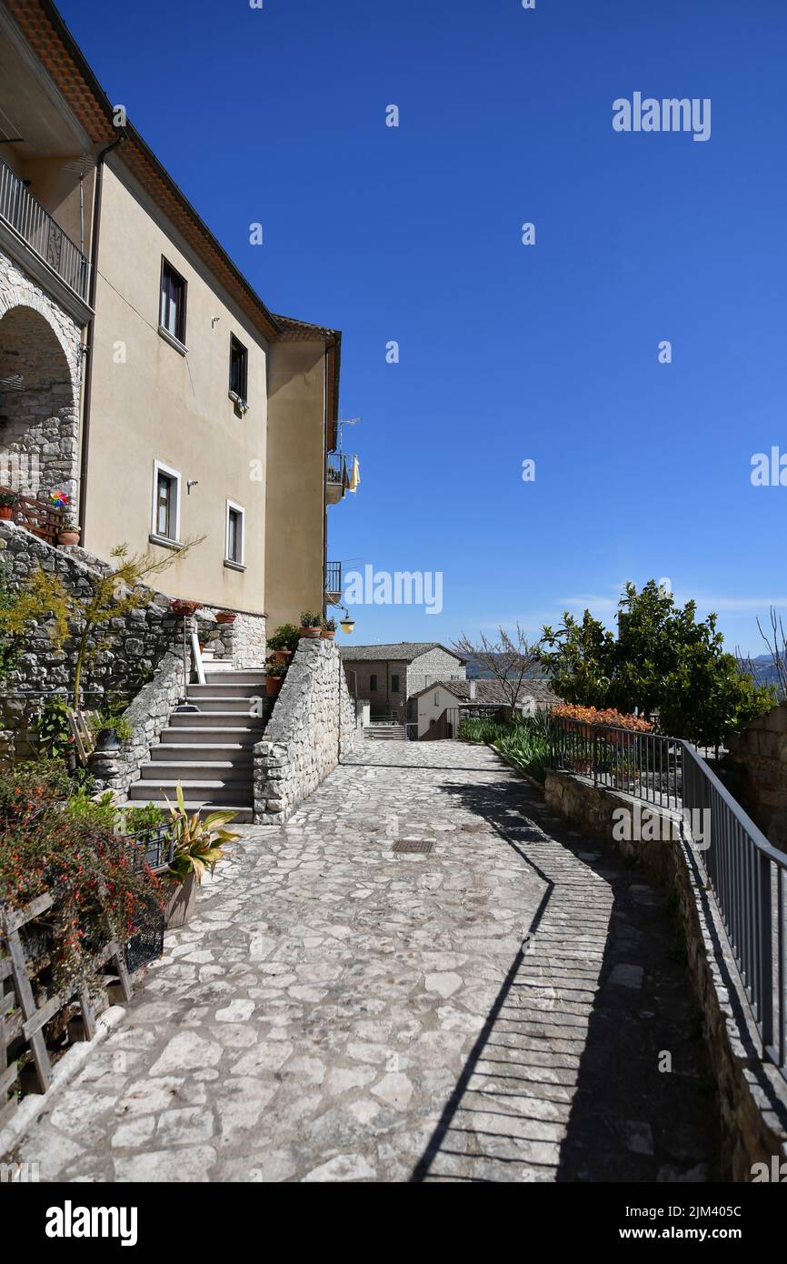 A Narrow brick street with houses under a blue sky in a small village ...