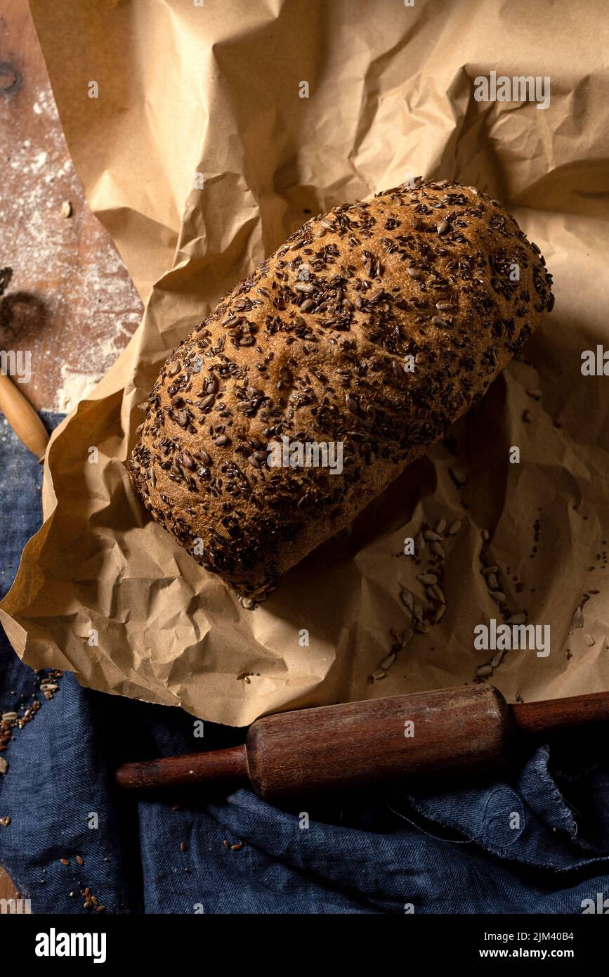 A vertical closeup of homemade sourdough bread with seeds Stock Photo ...