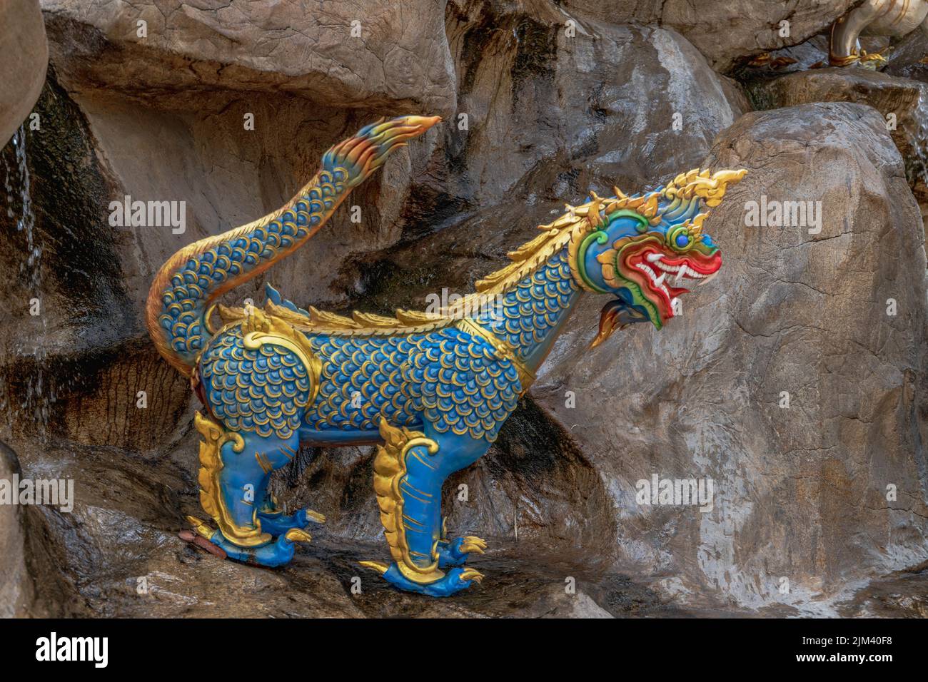 A closeup of a mythical beast statue in a buddhist temple in Thailand ...