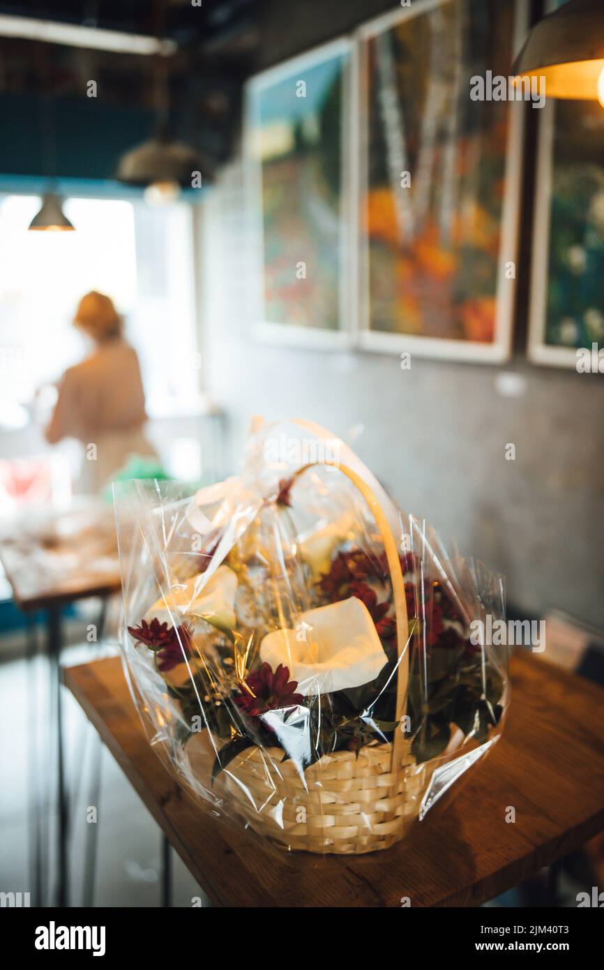 The flowers in a basket wrapped in cellophane Stock Photo - Alamy