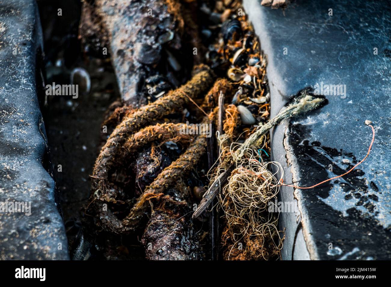 A closeup shot of old ropes on a rusty iron surface Stock Photo - Alamy