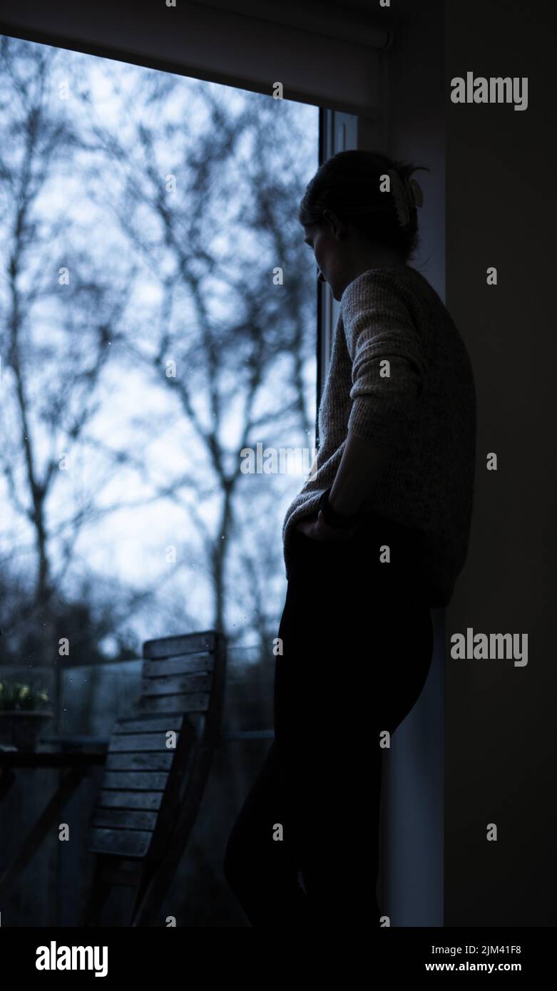 A back view of a male by the window Stock Photo - Alamy