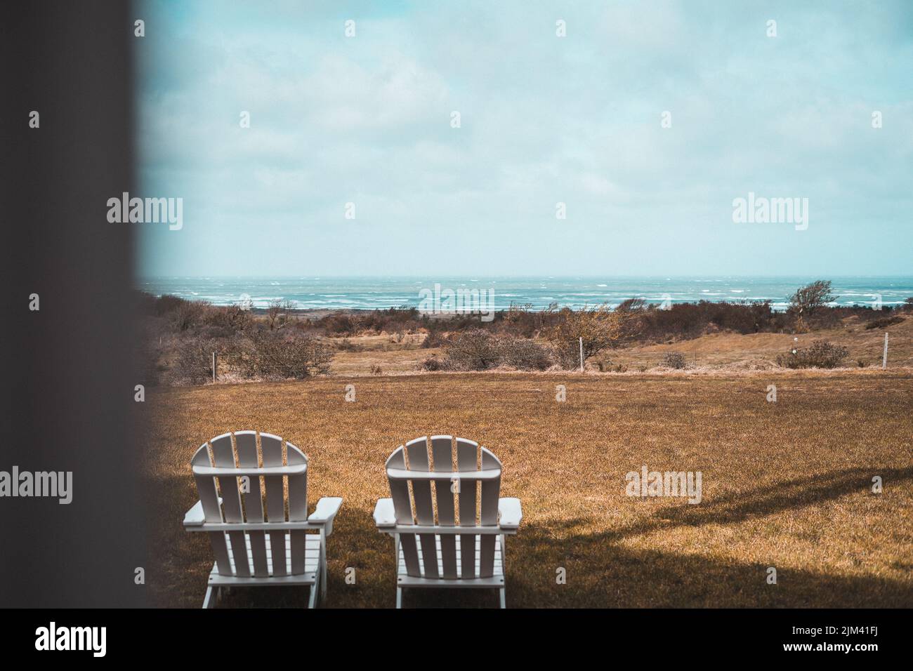 A back view of two adirondack chairs Stock Photo - Alamy