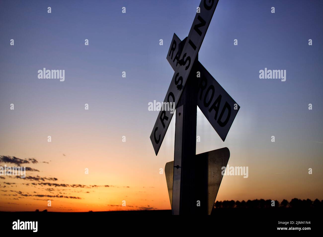 A railroad crossing sign in Nebraska at sunset Stock Photo - Alamy