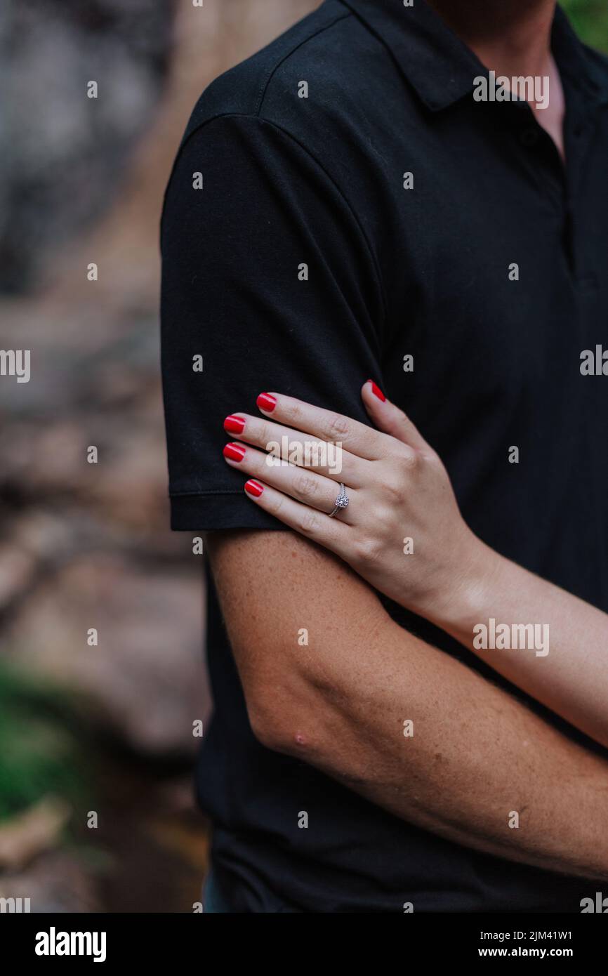 A beautiful portrait of a female hand showing her engagement ring while ...