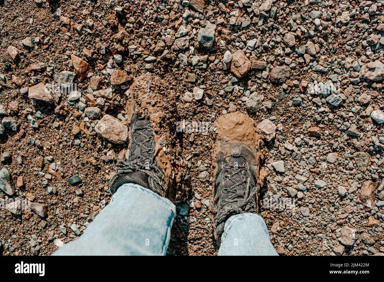 A top shot of human legs standing on Hopewell rock park ground and the ...
