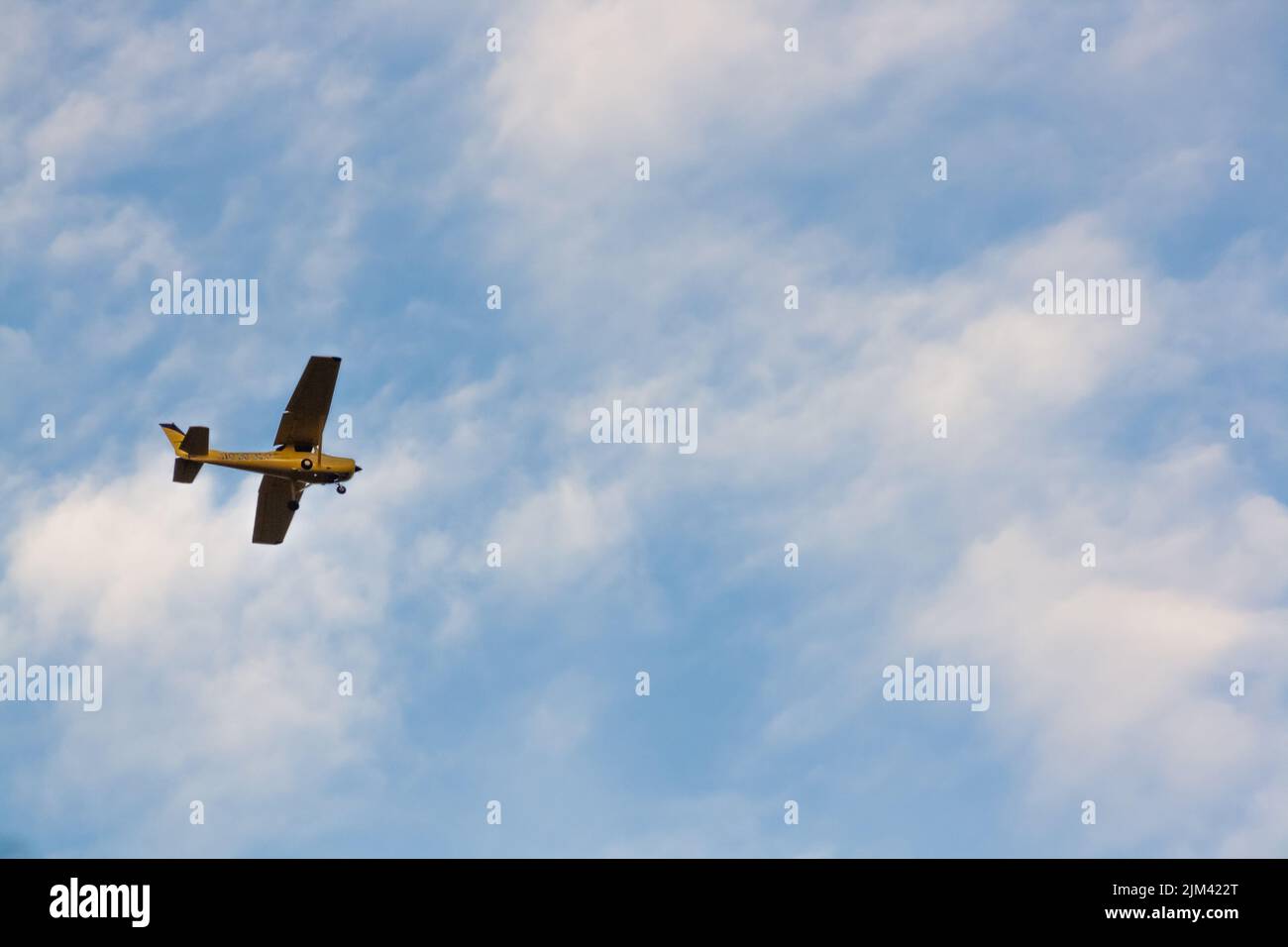 monoplane in blue sky with wispy light clouds Stock Photo - Alamy