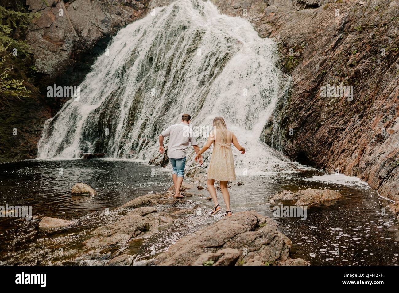 Woman walking tropical forest waterfall hi-res stock photography and ...