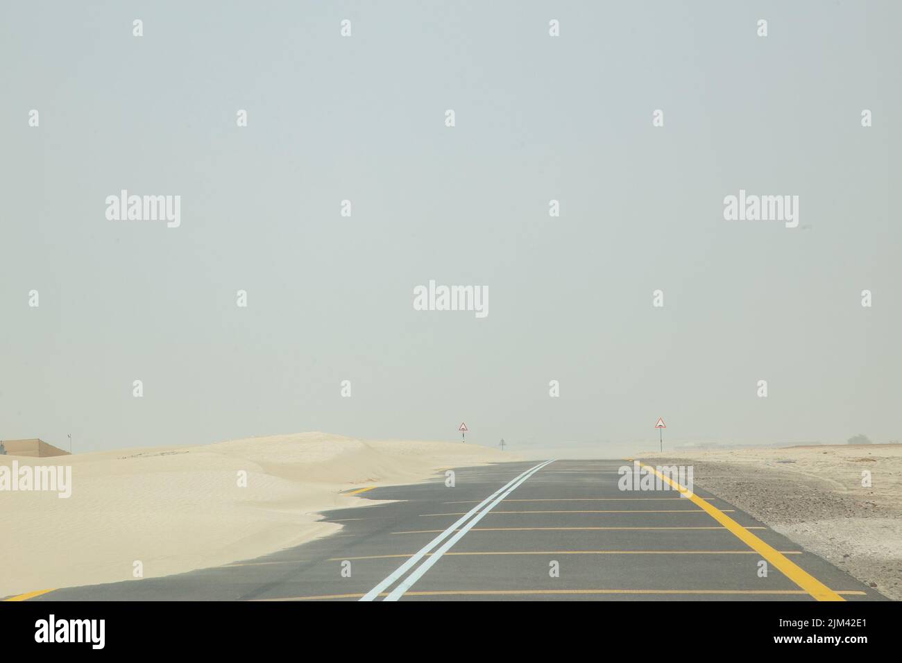 sand covering road blowing acr Stock Photo - Alamy