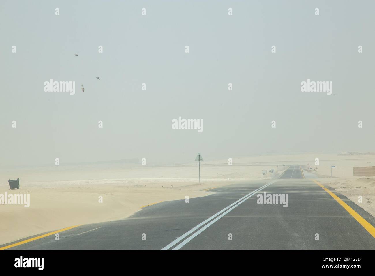 sand covering road blowing acr Stock Photo - Alamy