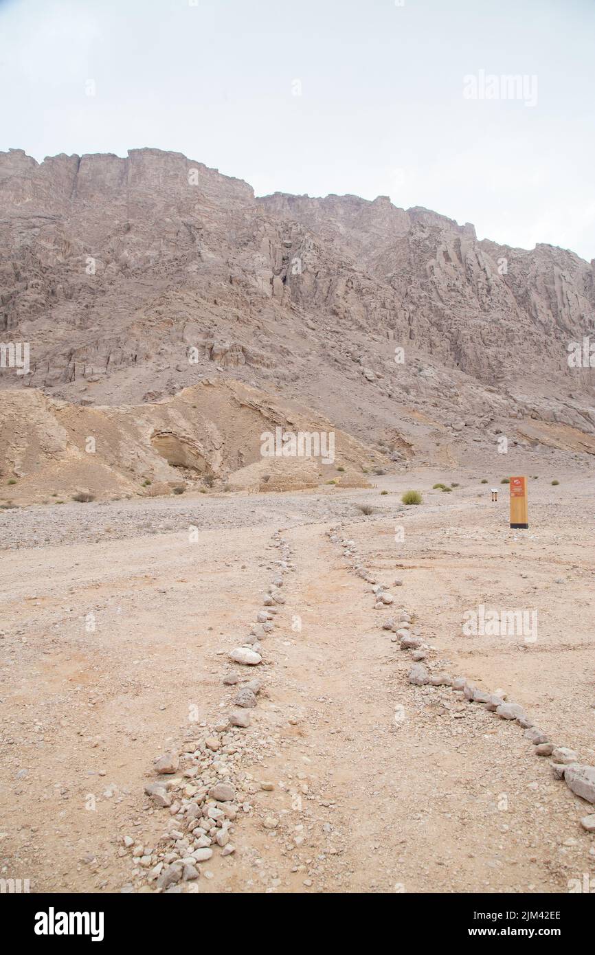 desert path with mountains and valleys dry out of focus with grain ...