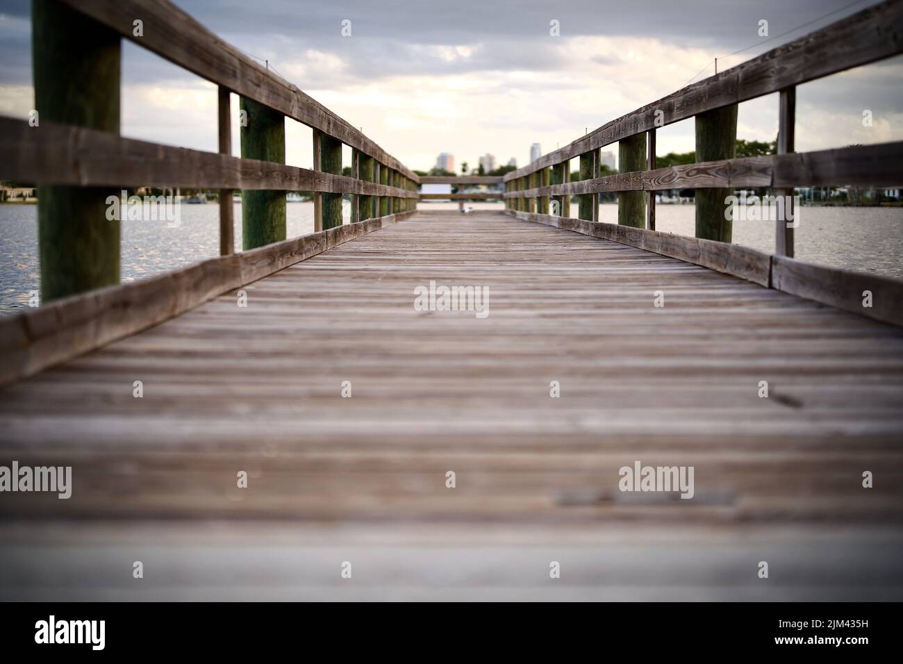 A dock out into the water leading to a city view Stock Photo - Alamy