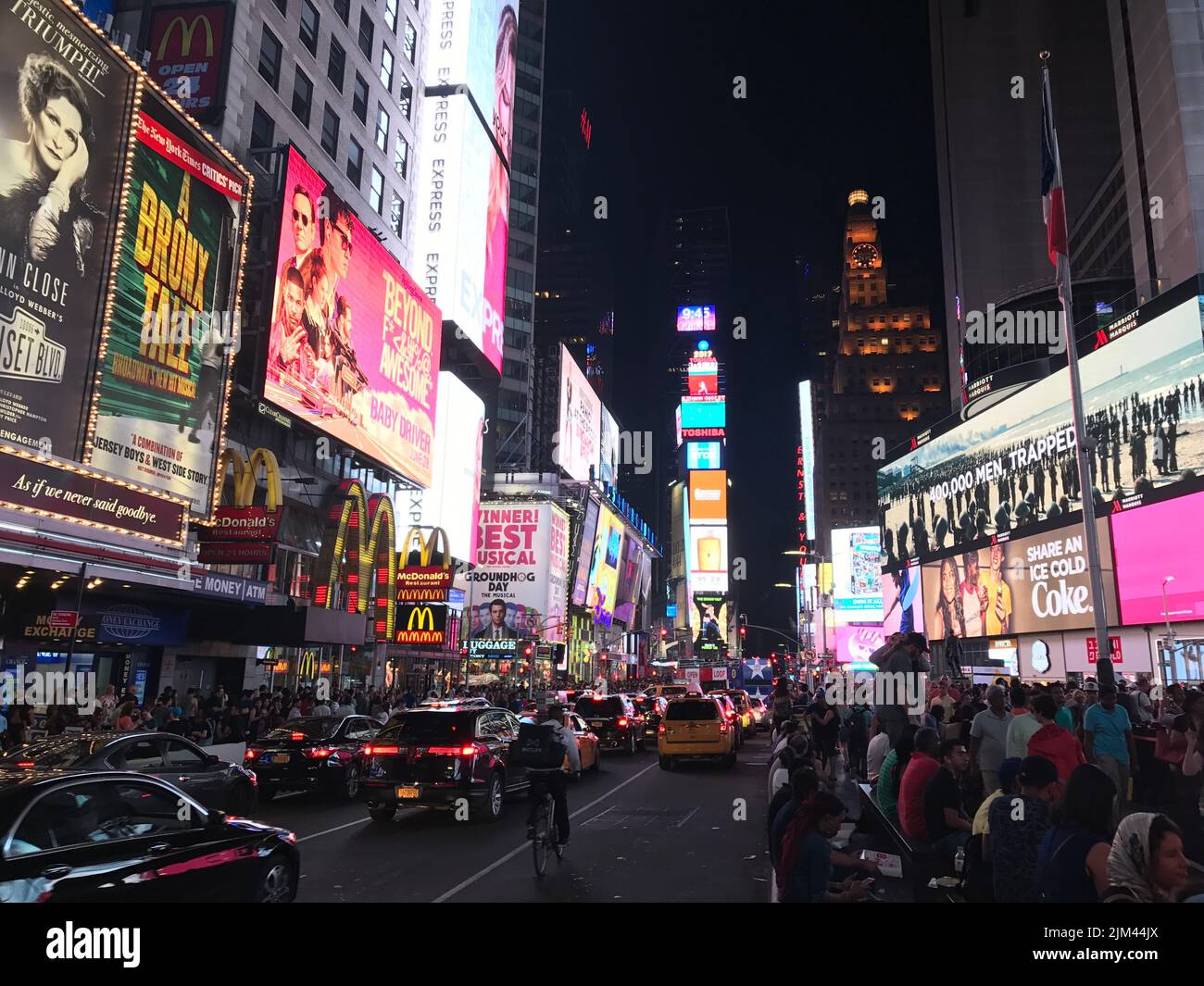 A low angle shot of Times Square billboards shining bright at night ...