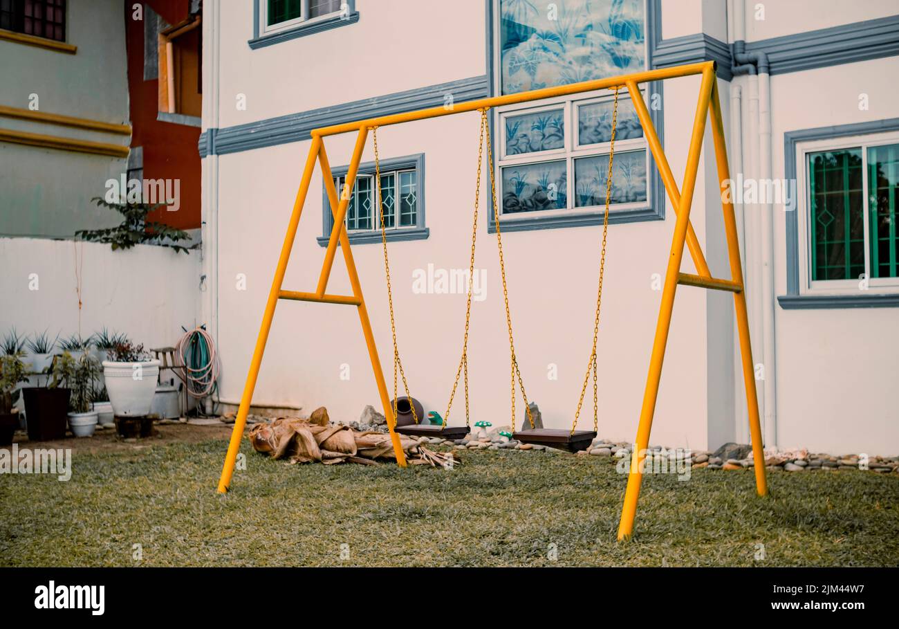 The two swings in front of the building Stock Photo - Alamy