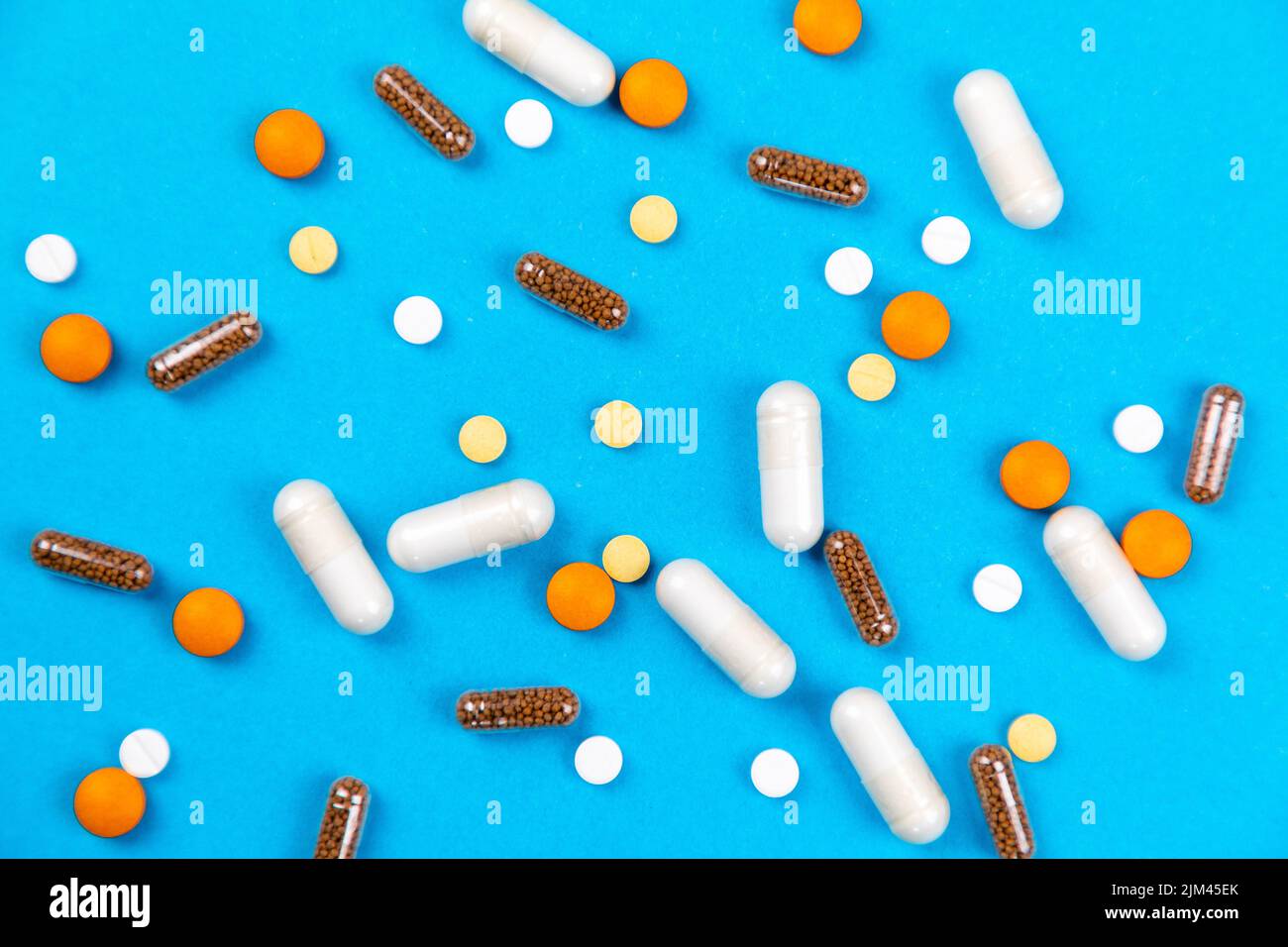 A top view of tablets of medicaments on a blue background with copy ...