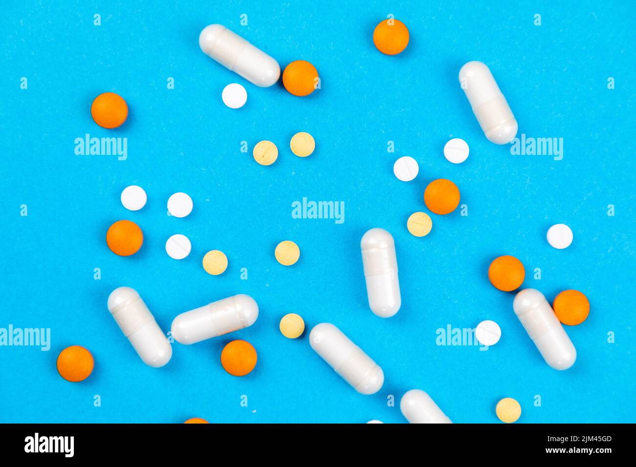 A top view of tablets of medicaments on a blue background with copy ...