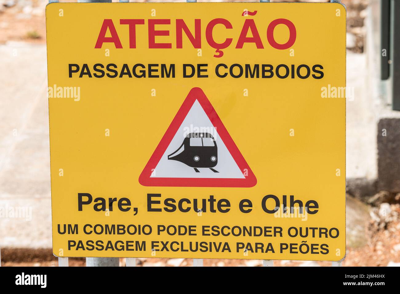 A Yellow caution warning information sign when crossing the train line ...