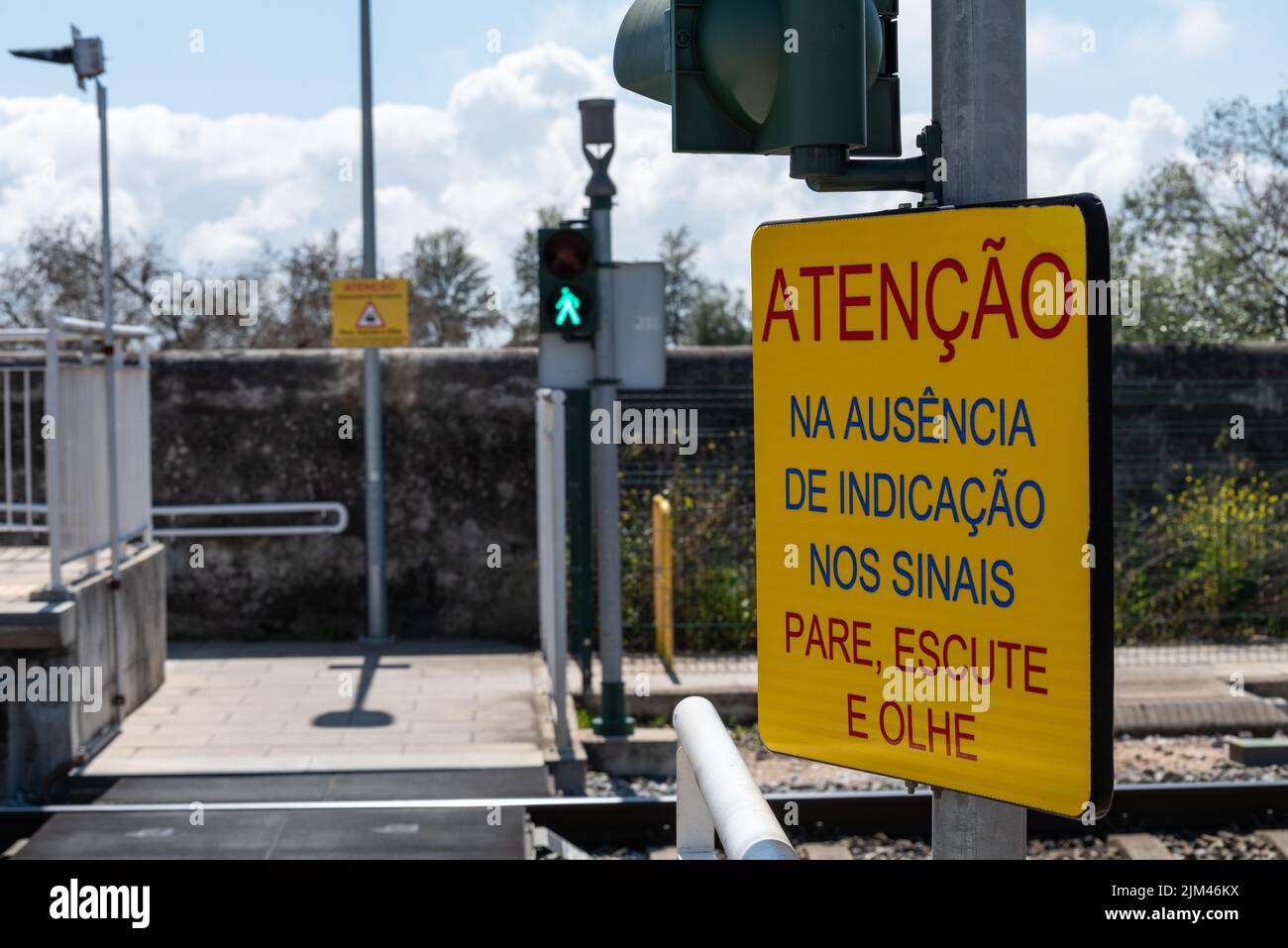A Yellow caution warning information sign when crossing the train line ...