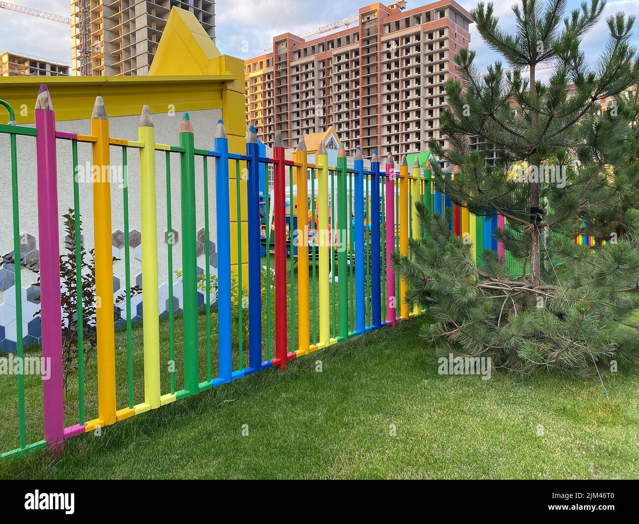 Colorful fence of a kindergarten or park in the form of colored pencils ...