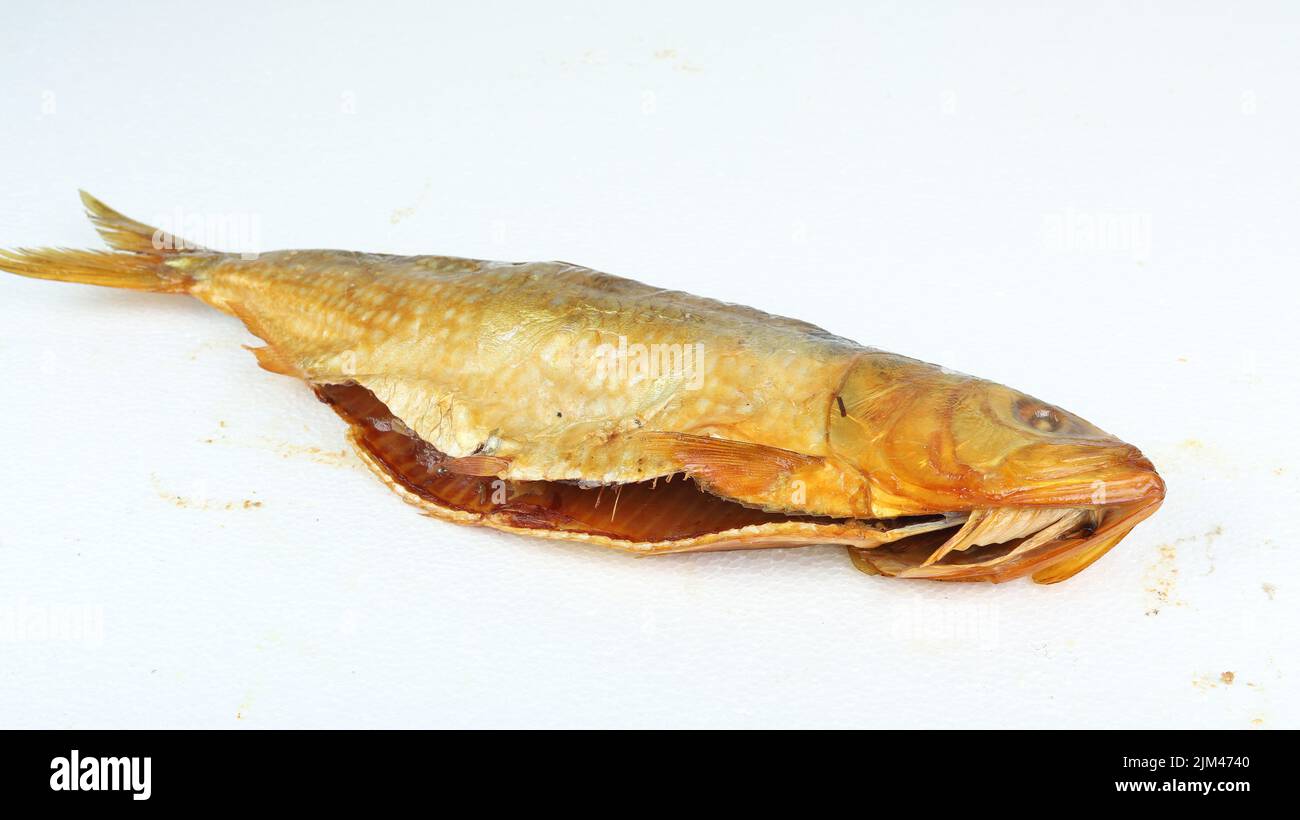 A Large smoked fish isolated on a white background Stock Photo - Alamy