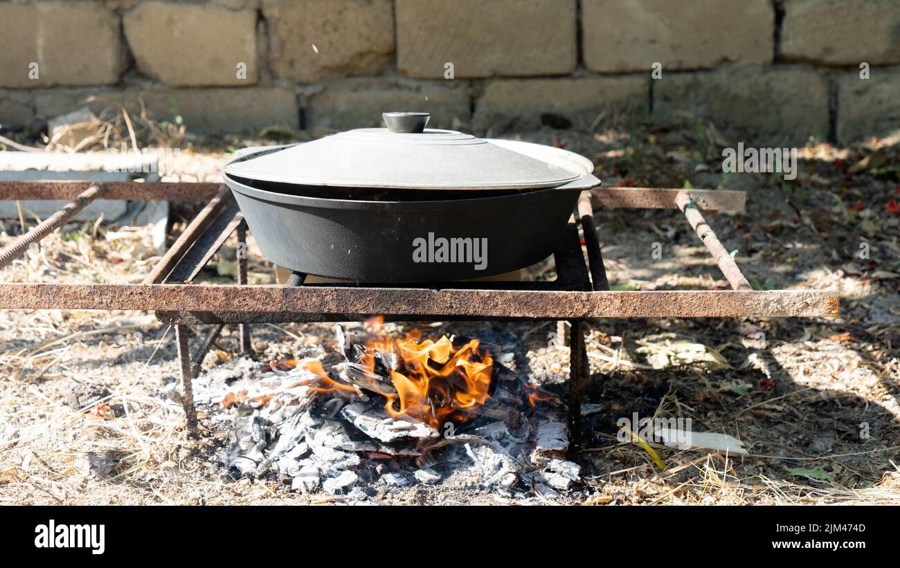 A meal preparation process in clay stove pottery on a fire Stock Photo ...