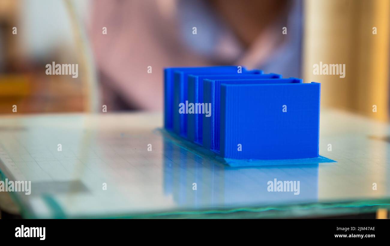 A closeup of a blue structure in a 3D printer Stock Photo - Alamy