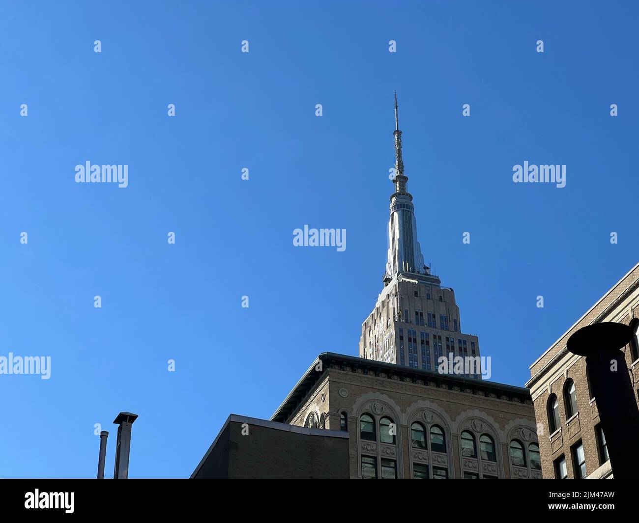 A low angle shot of the top of the Empire State building, NYC seen ...