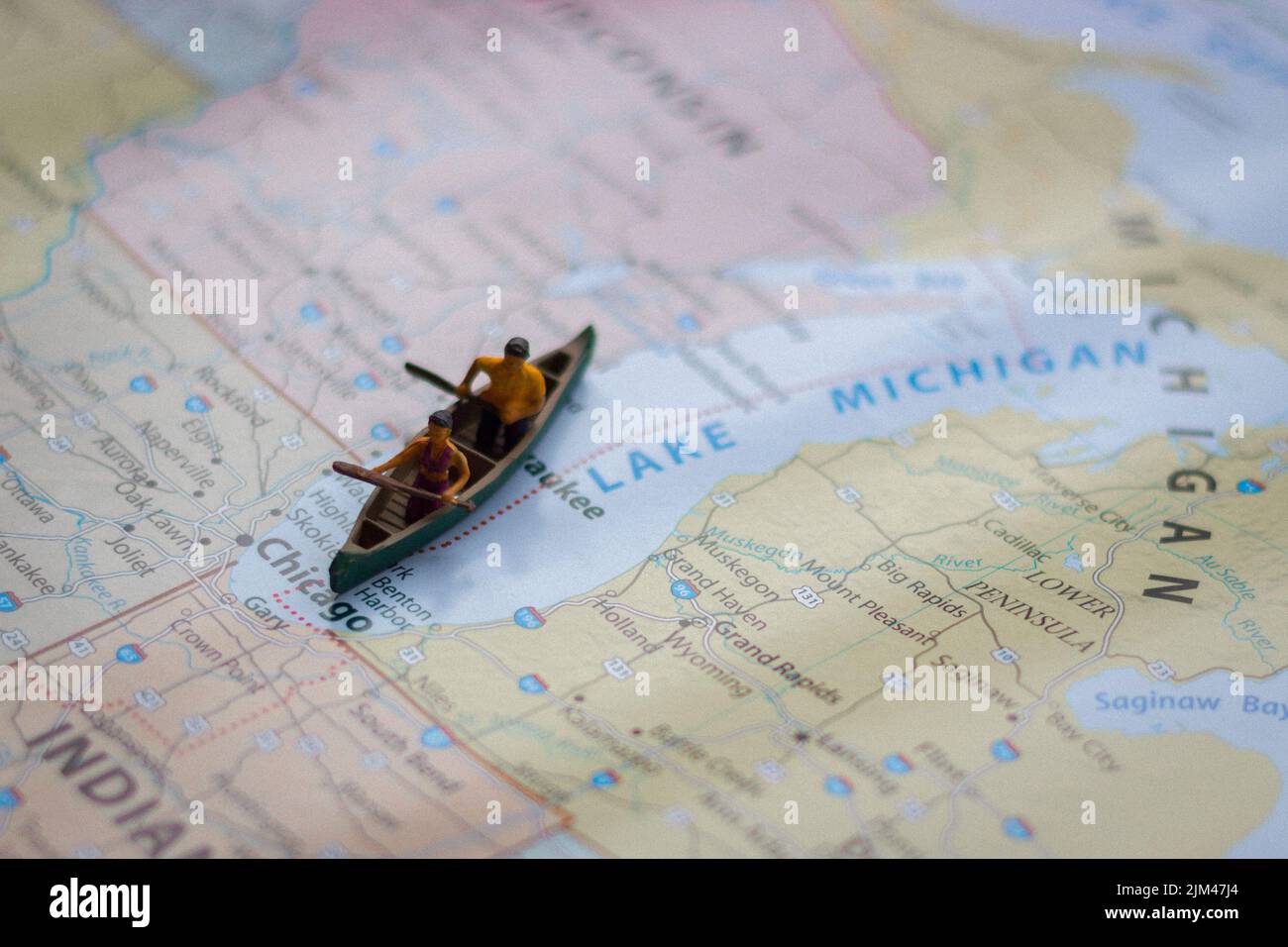 A boat figurine with two male sailors on a map Stock Photo - Alamy
