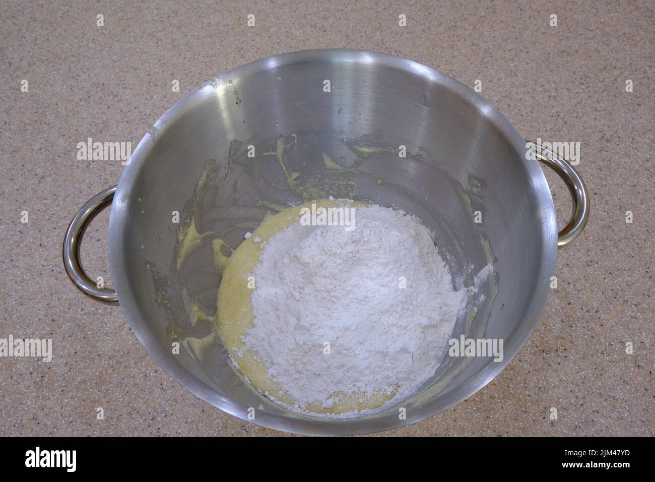 A top view of a bowl with whipped mixture and flour Stock Photo - Alamy