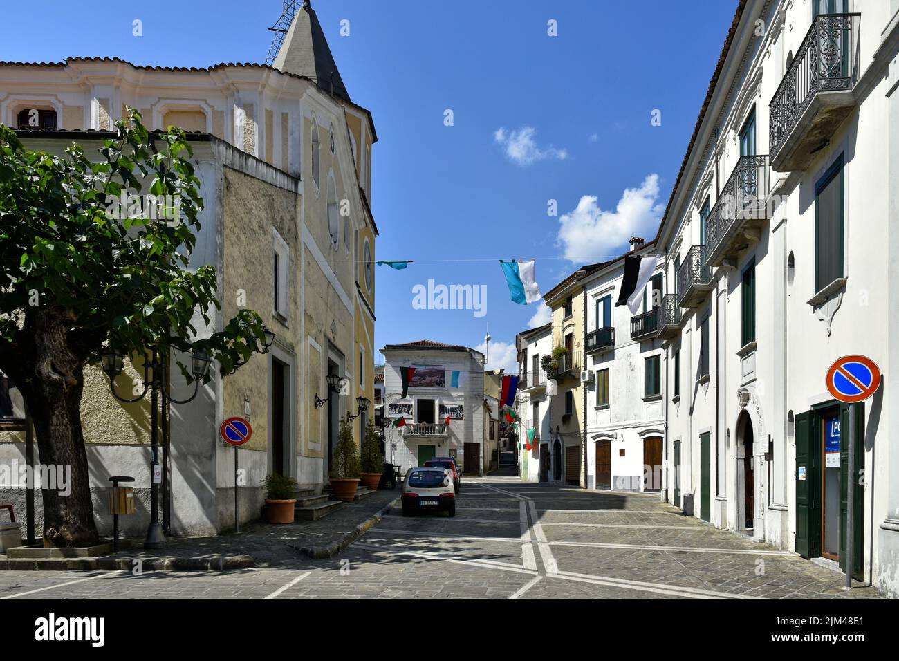 A narrow street among the old houses of Laino Borgo, a rural village in ...
