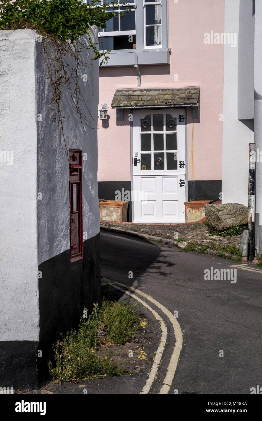 A Red Post Box In Whitewashed Wall Opposite Pastel Pink Cottage In ...