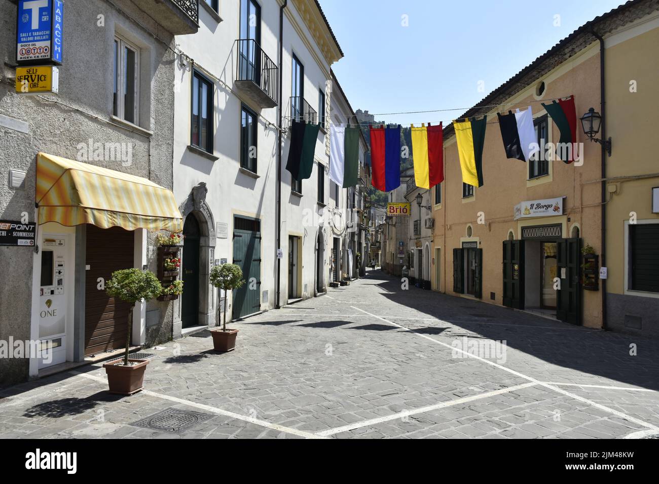 A narrow street among the old houses of Laino Borgo, a rural village in ...