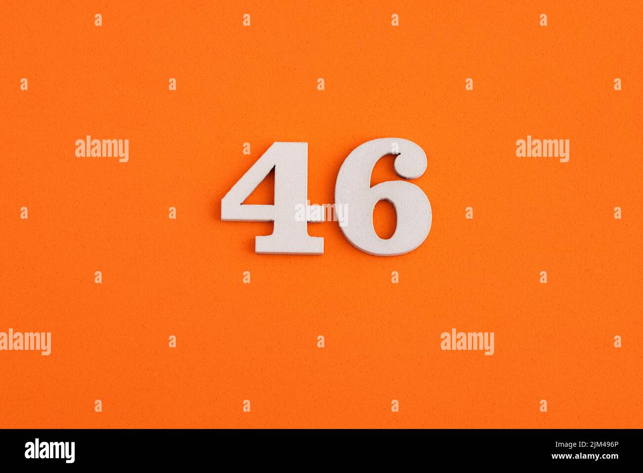 White wooden number 46 on eva rubber orange background Stock Photo - Alamy