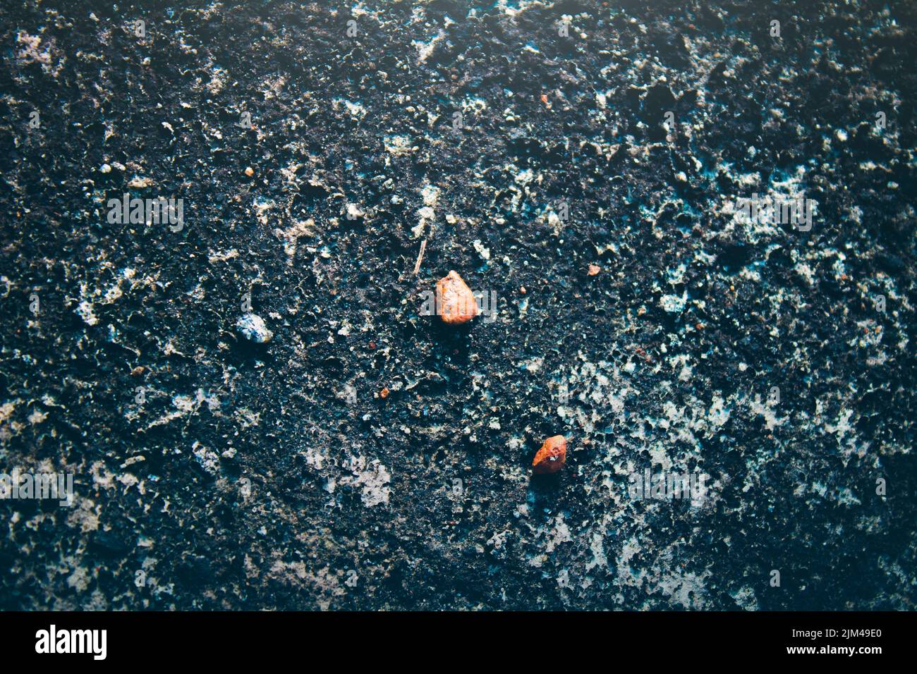 Tiny orange pebbles on the concrete slab Stock Photo - Alamy