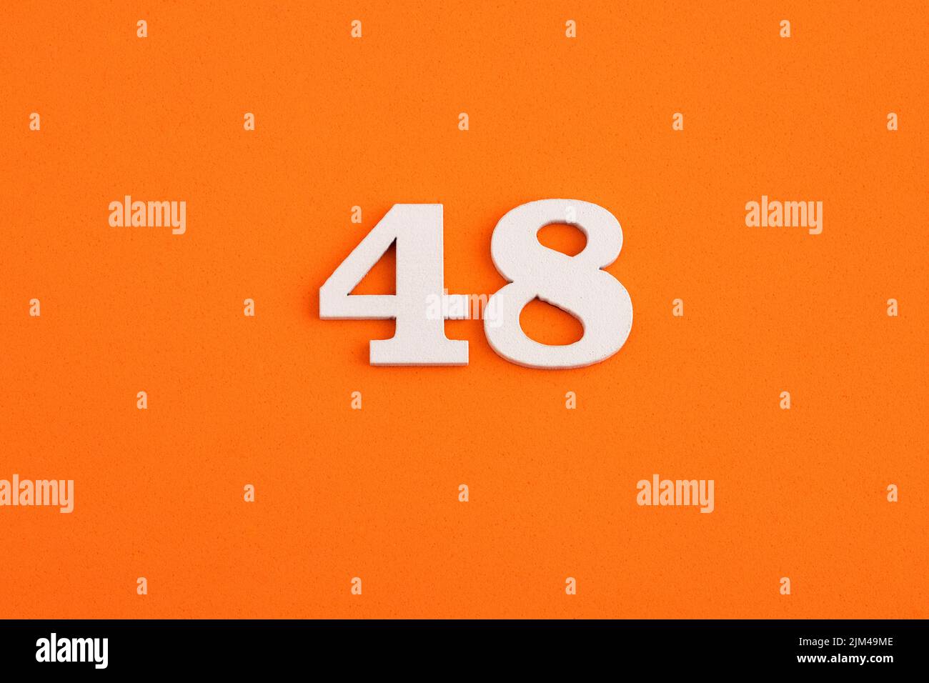 White wooden number 48 on eva rubber orange background Stock Photo - Alamy