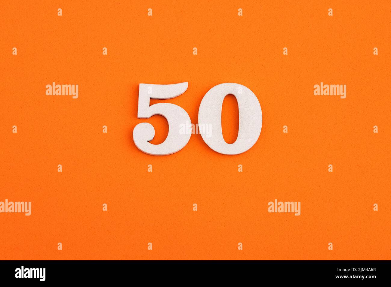 White wooden number 50 on eva rubber orange background Stock Photo - Alamy
