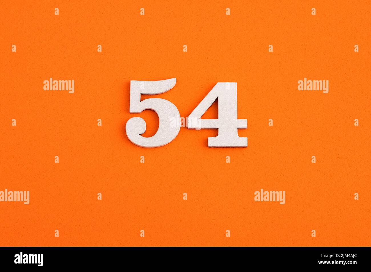 White wooden number 54 on eva rubber orange background Stock Photo - Alamy